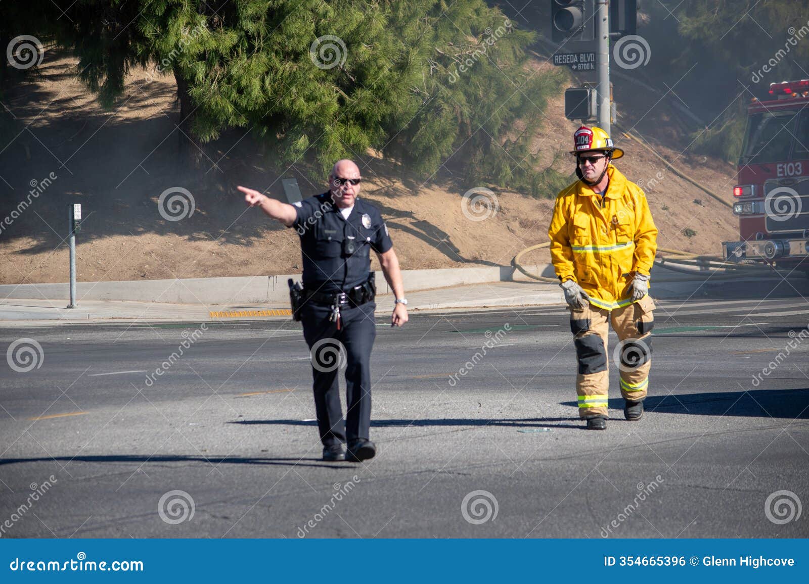 LAPD Sergeant Gestures and Directs Traffic Around the Scene of a Fire ...