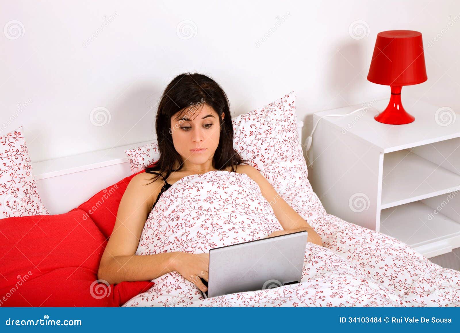 Laptop in bed stock photo. Image of notebook, female - 34103484