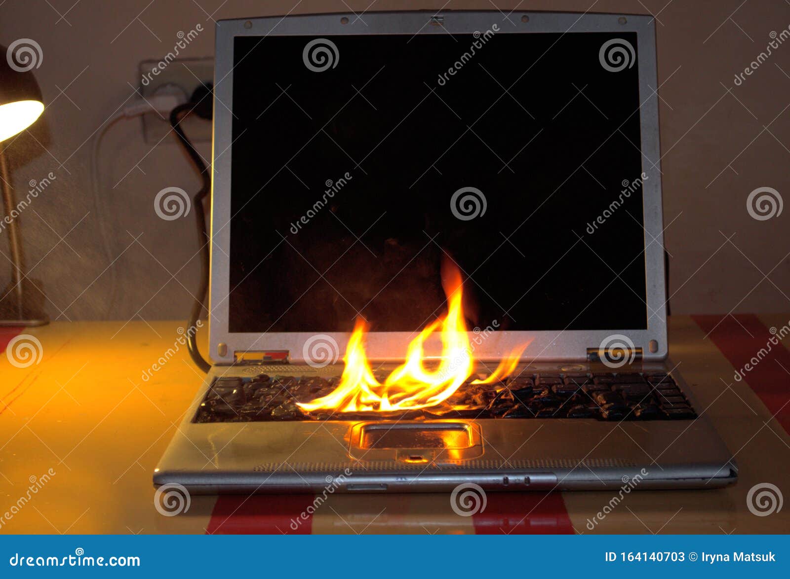 A Laptop Burns on a Table in a Room Stock Image - Image of blazing ...