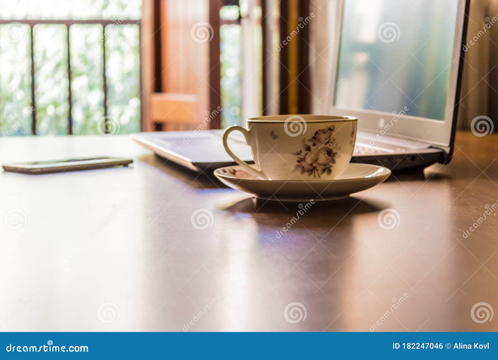 Laptop, Cell Phone and a Tea Cup on the Desk, Business from Anywhere ...