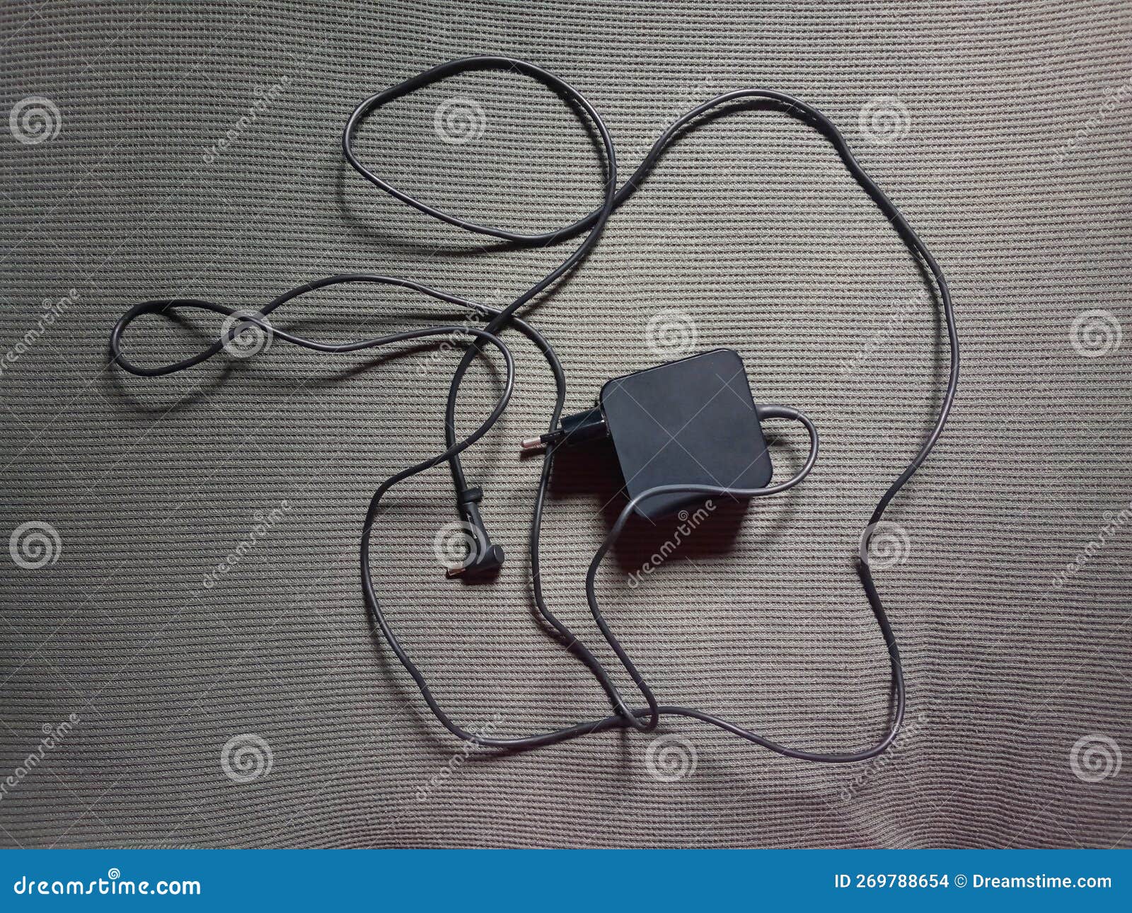 Laptop Charger with Its Messy Cable on a Structured Surface Stock Photo ...