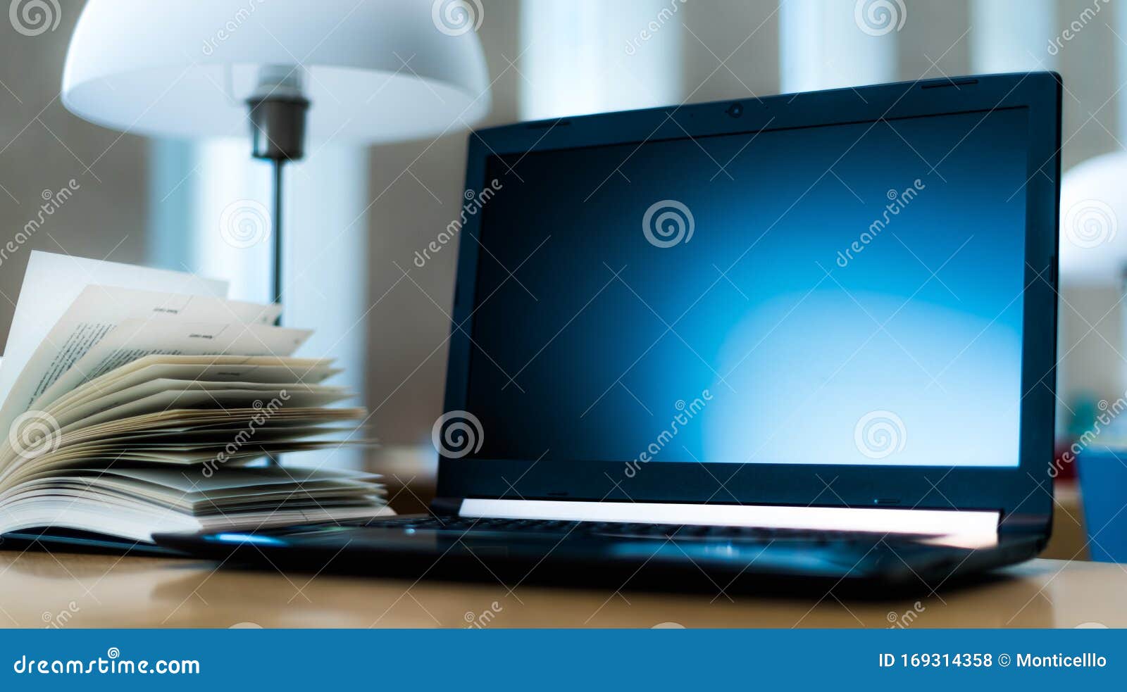 Laptop Computer and a Book on the Desk in Public Library Stock Photo ...