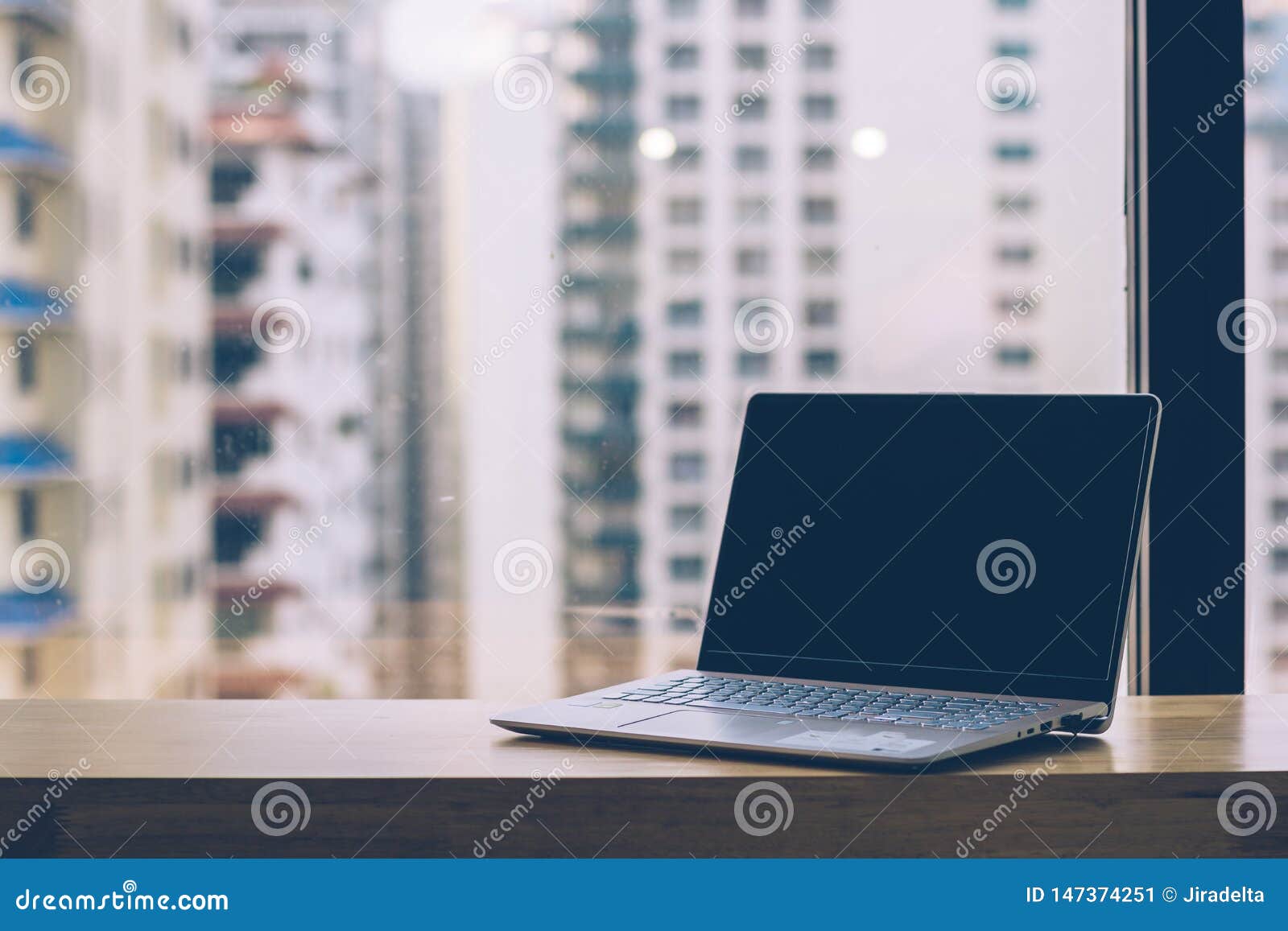 Laptop Computer on Counter Near Glass Windows of Office Building Stock ...