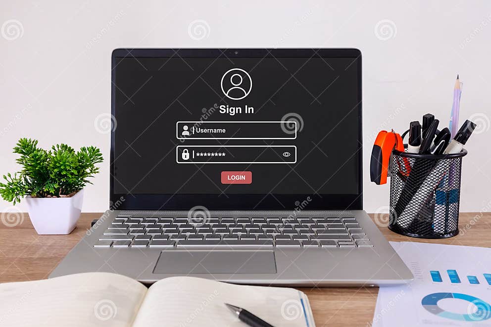A Laptop Computer on the Desk with a Login Page on the Screen Stock ...