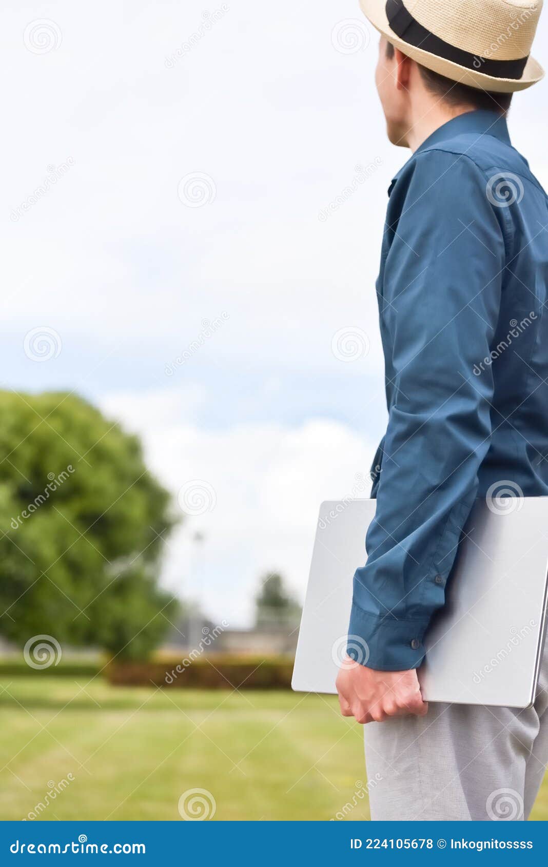 A Laptop Computer in the Hand of a Man Who Thinks and Looks into the ...