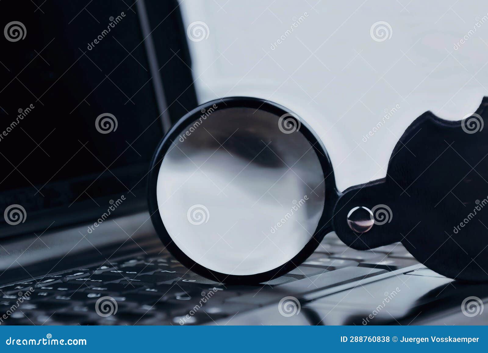 Laptop Computer with Keyboard and Magnifying Glass on Top, Representing ...