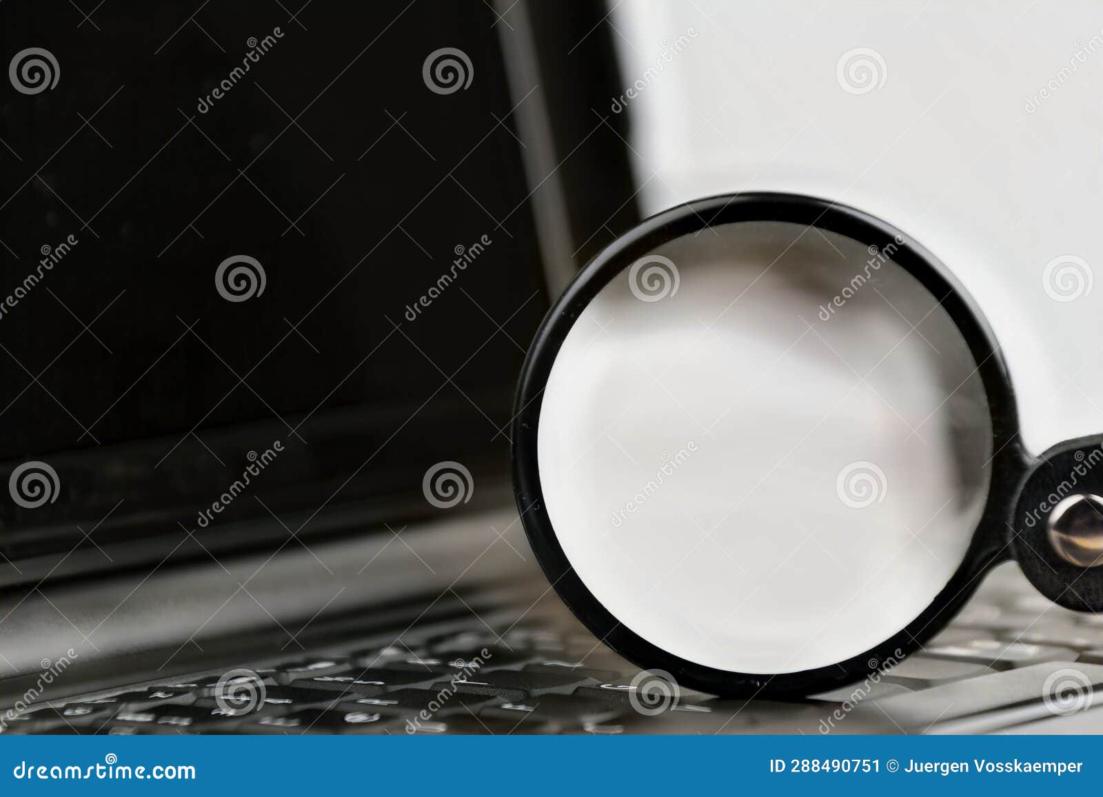 Laptop Computer with Keyboard and Magnifying Glass on Top, Representing ...