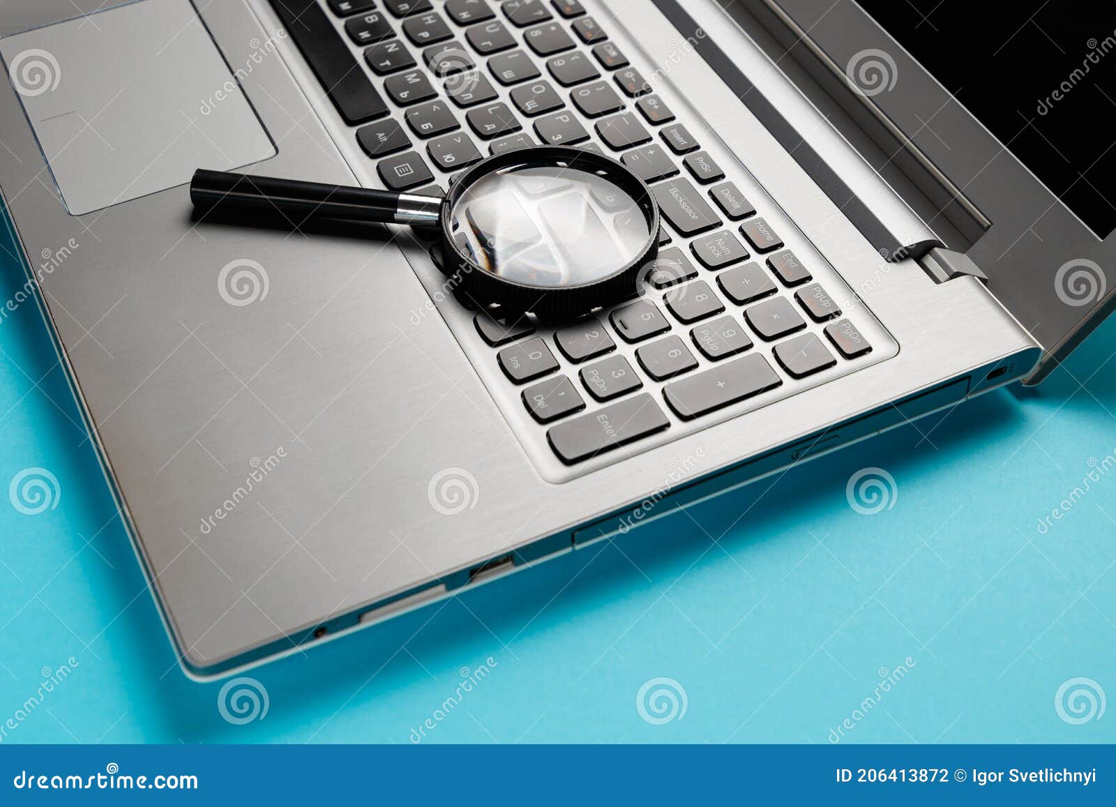 Laptop Computer with Magnifying Glass on Blue Background, Concept of ...