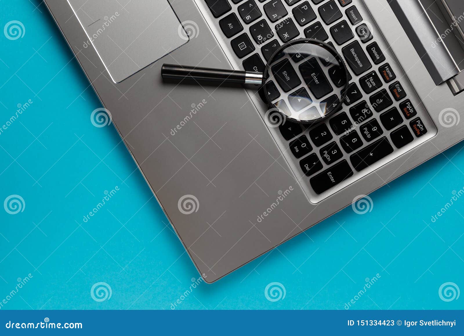 Laptop Computer with Magnifying Glass on Blue Background, Concept of ...