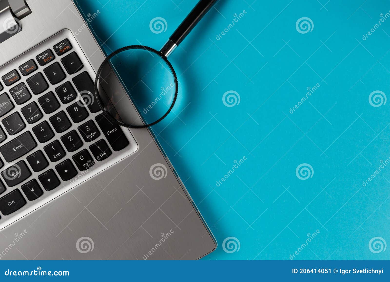 Laptop Computer with Magnifying Glass on Blue Background, Concept of ...
