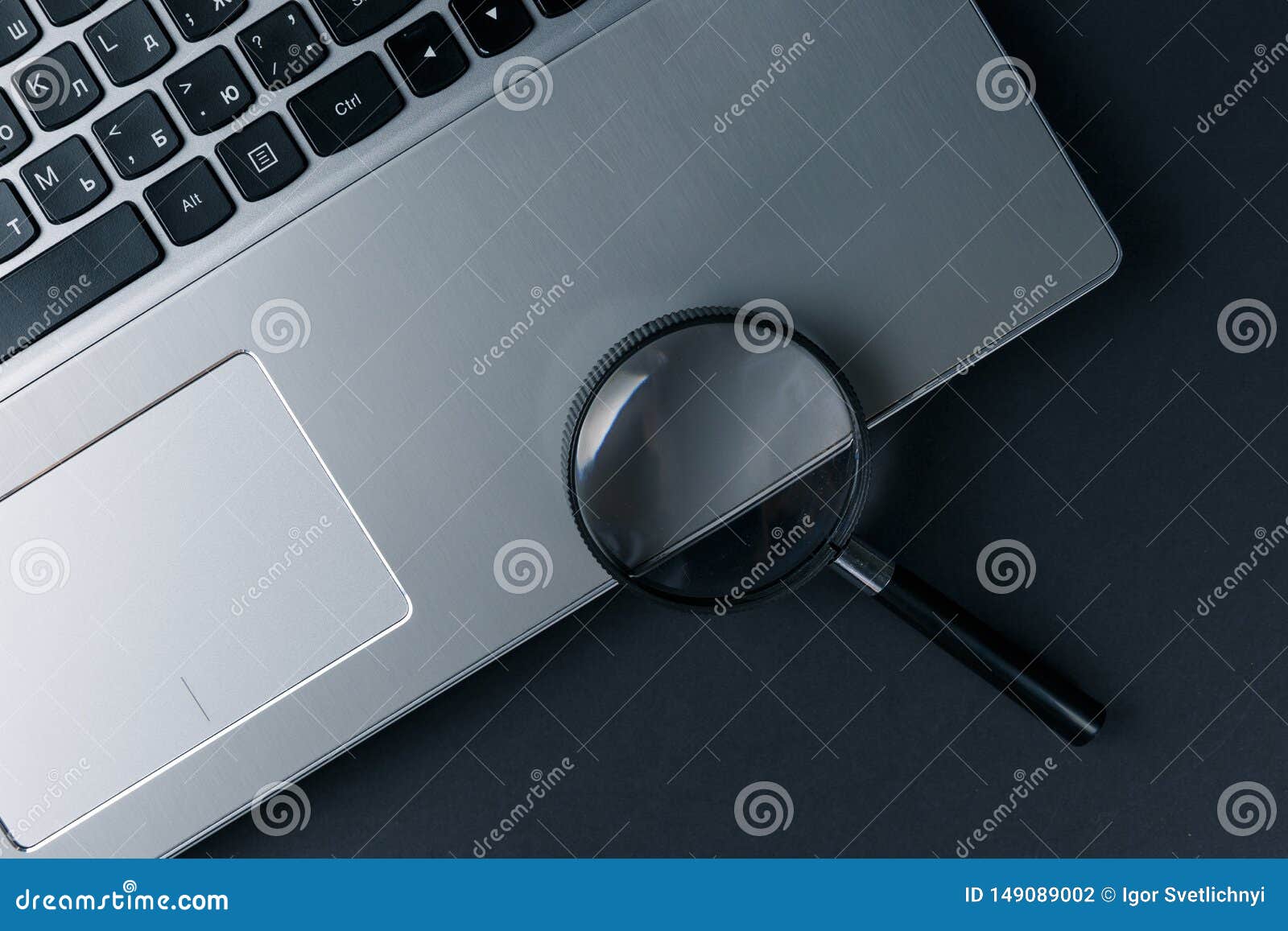 Laptop Computer with Magnifying Glass on Dark Background, Concept of ...