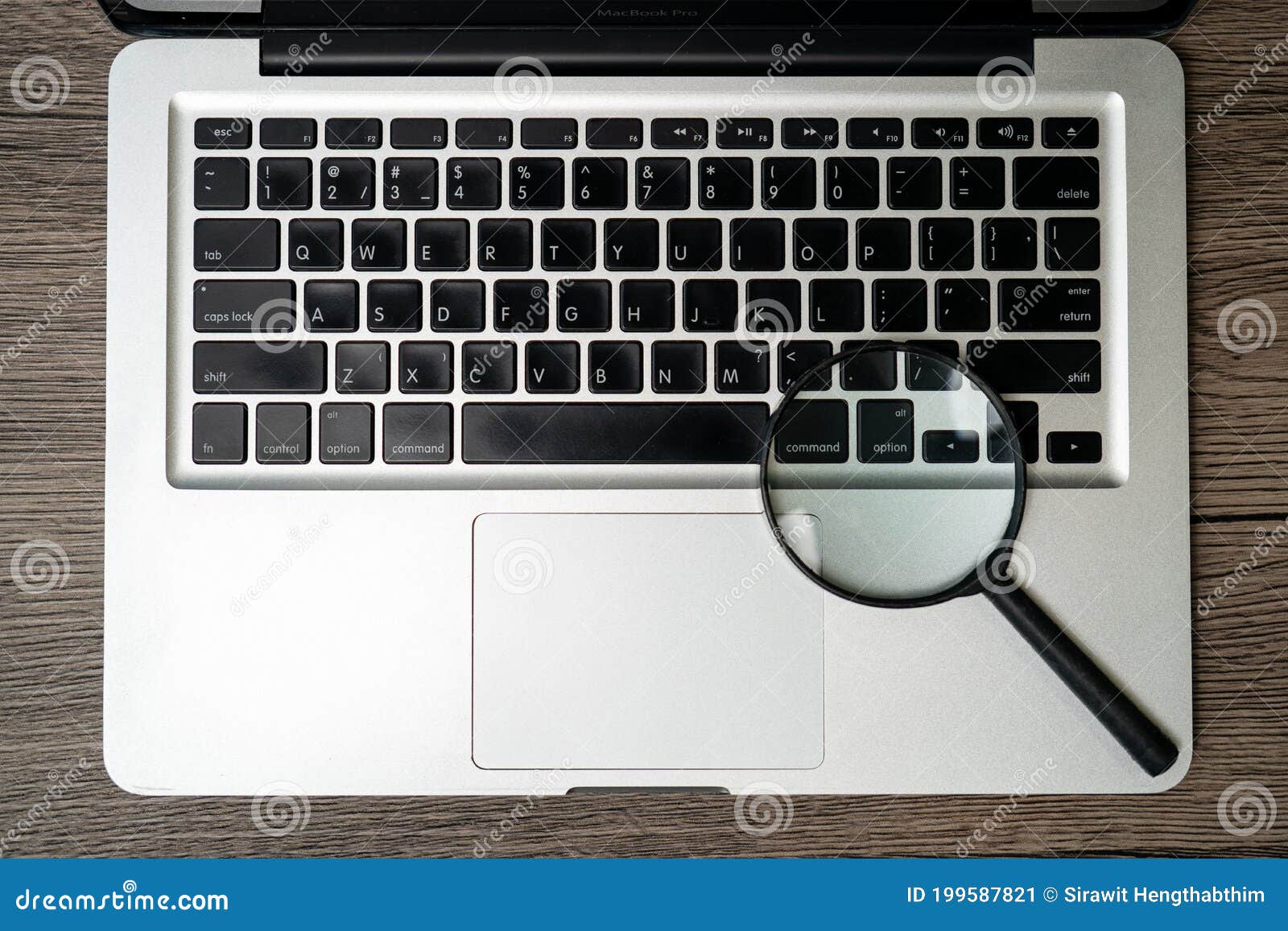 Laptop Computer with Magnifying Glass on the Laptop Keyboard, Concept ...