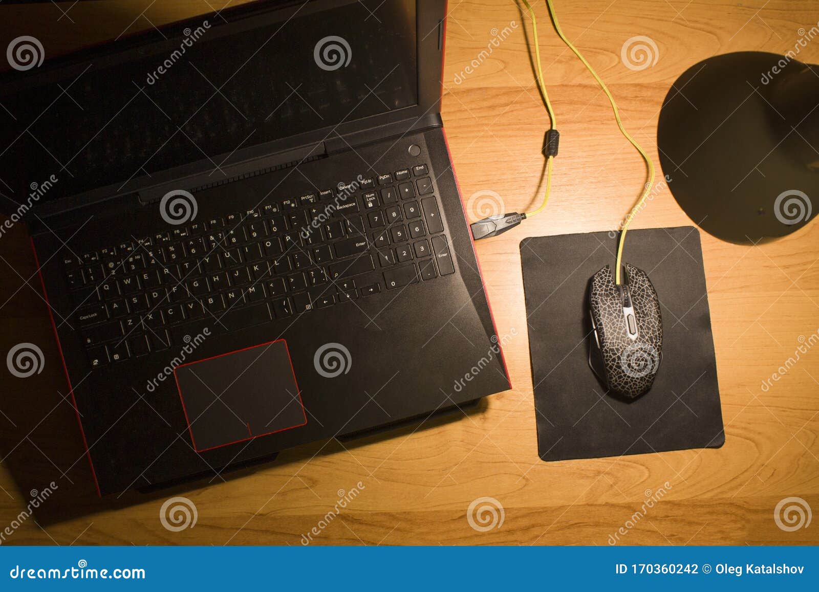 Laptop with a Computer Mouse on the Table Under the Light of a Desk ...
