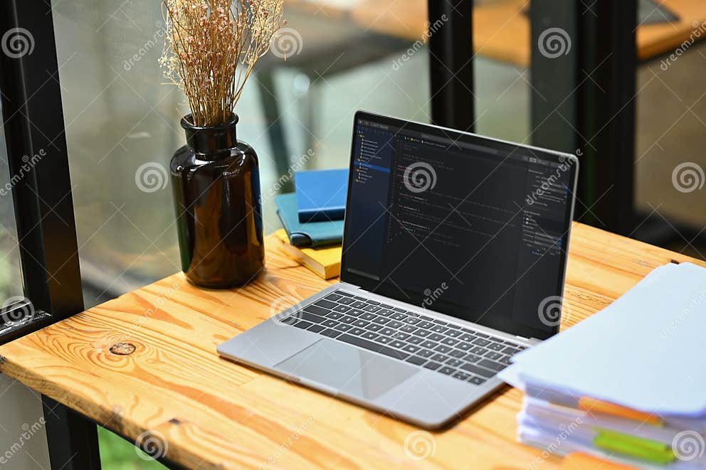 Laptop Computer with Programming Code, Document and Notepad on Wooden ...