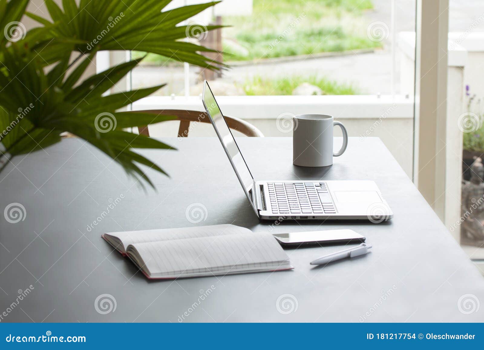 Laptop Computer on a Table with Coffee Mug, Notepad, Mobile Phone and ...