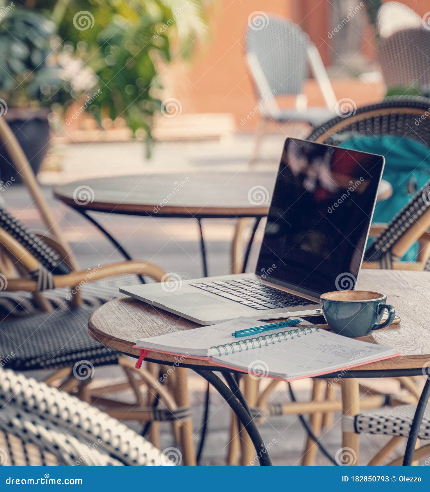 Laptop, a Cup of Coffee and a Notebook with a Pen on a Table in an ...