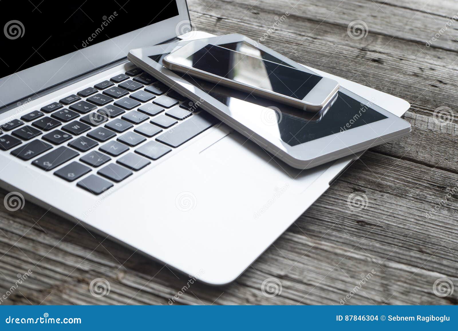 Laptop with Digital Tablet and Mobile Phone on Wooden Table Stock Photo ...