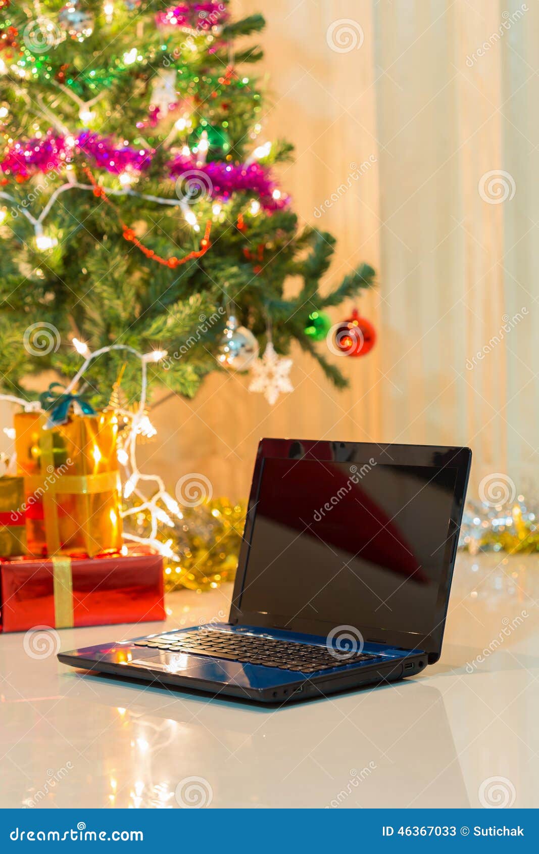 Laptop with Gift Box and Christmas Lights Stock Image - Image of gold ...