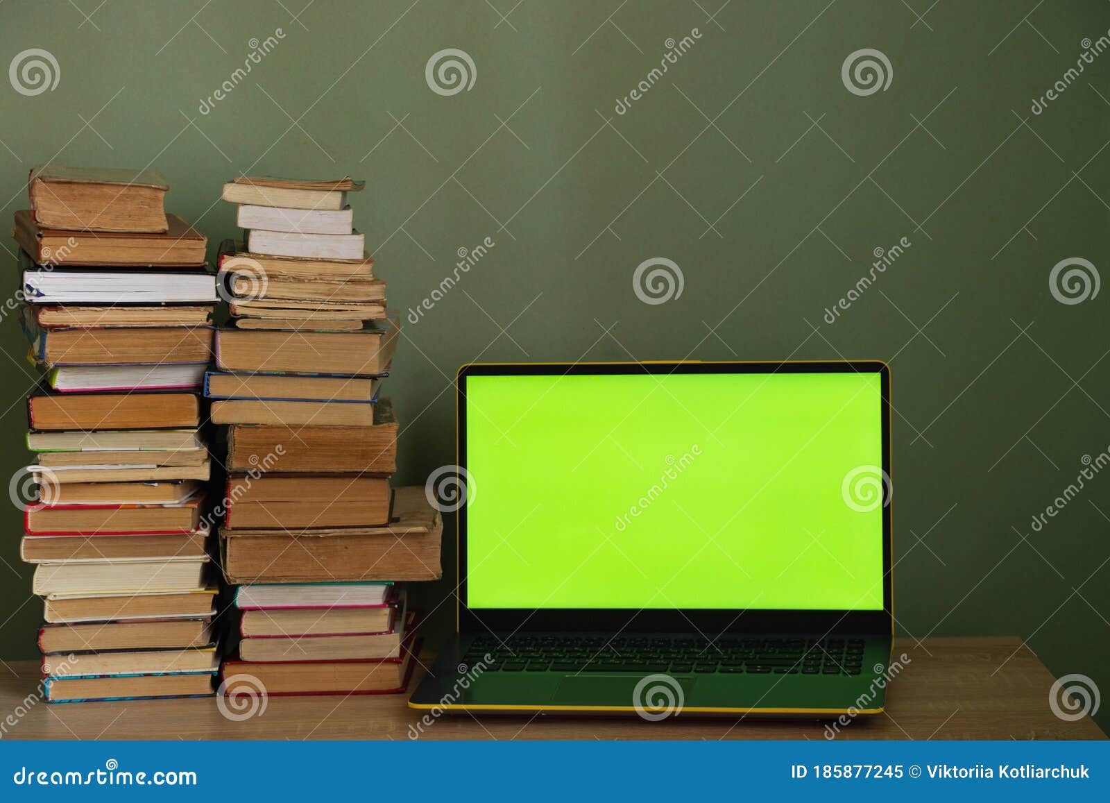 Laptop Green Screen and a Stack of Books on the Table in the Workplace ...