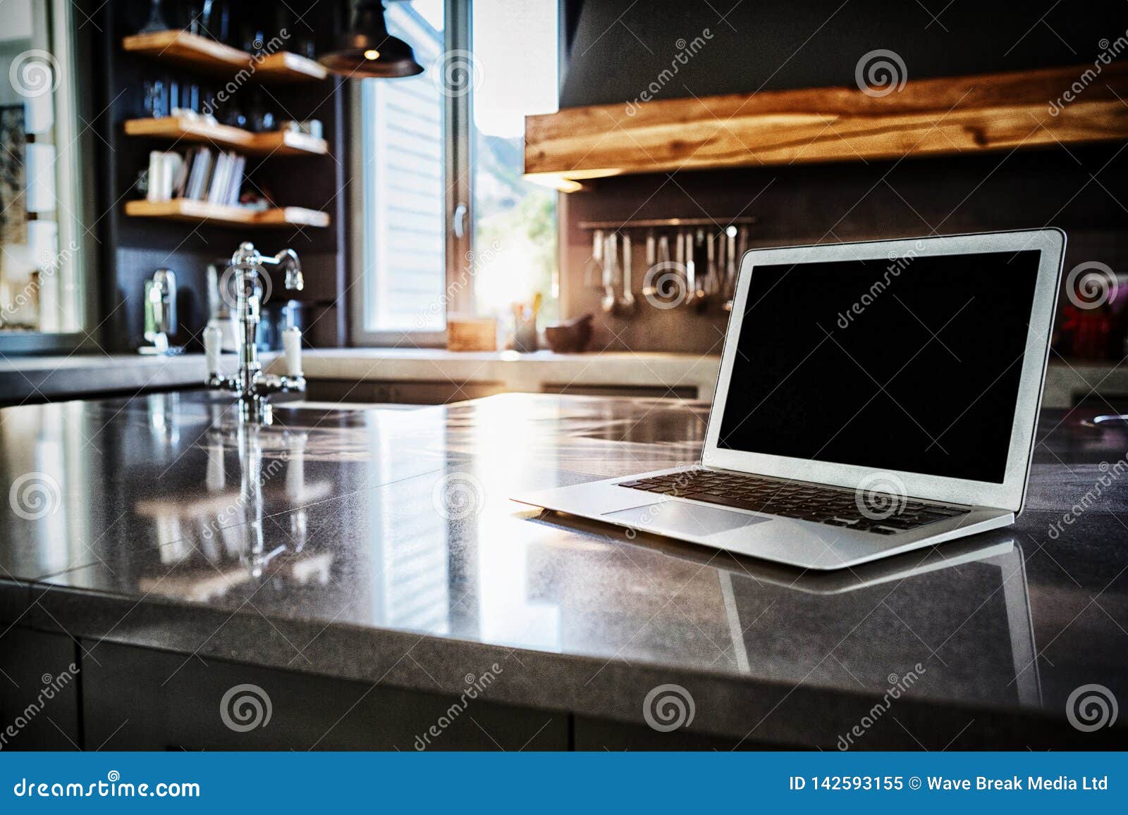 Laptop on kitchen counter stock image. Image of focus - 142593155