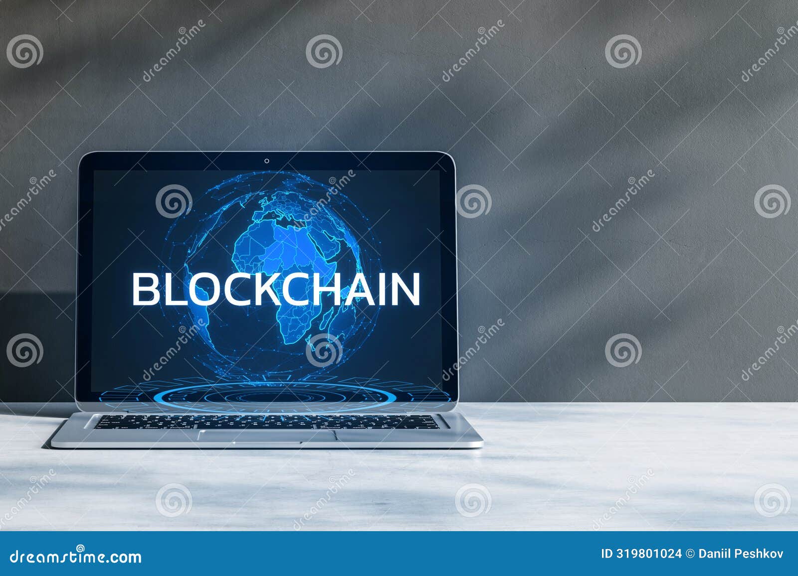 A Laptop on a Marble Surface Displays the Word BLOCKCHAIN with a ...