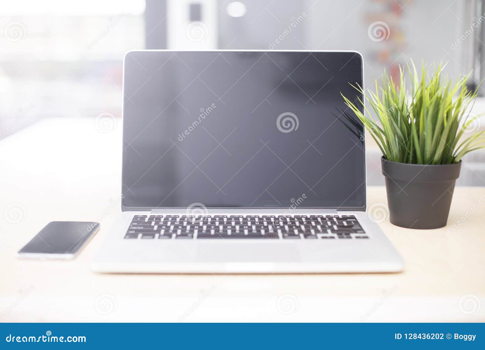 Laptop and Mobile Phone on a Desk Stock Photo - Image of table, wood ...