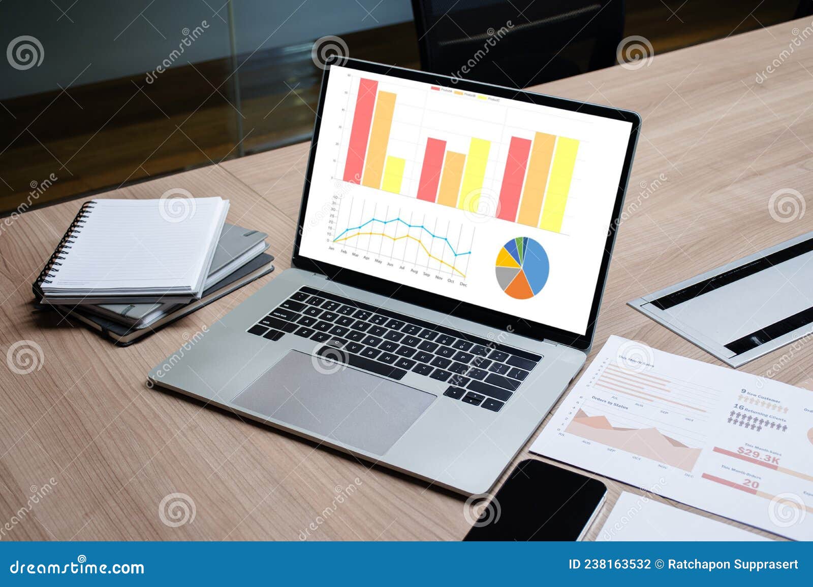 Laptop with Mock Up Chart Slide Show on Display and Paperwork on Table ...