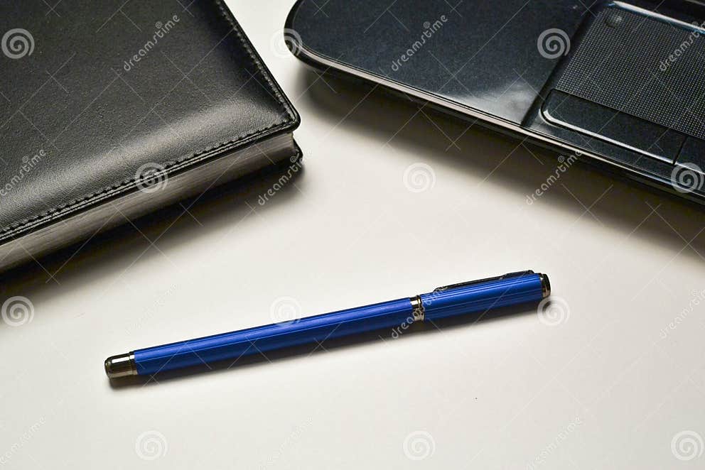 Laptop, notebook and pen stock image. Image of table - 82185045