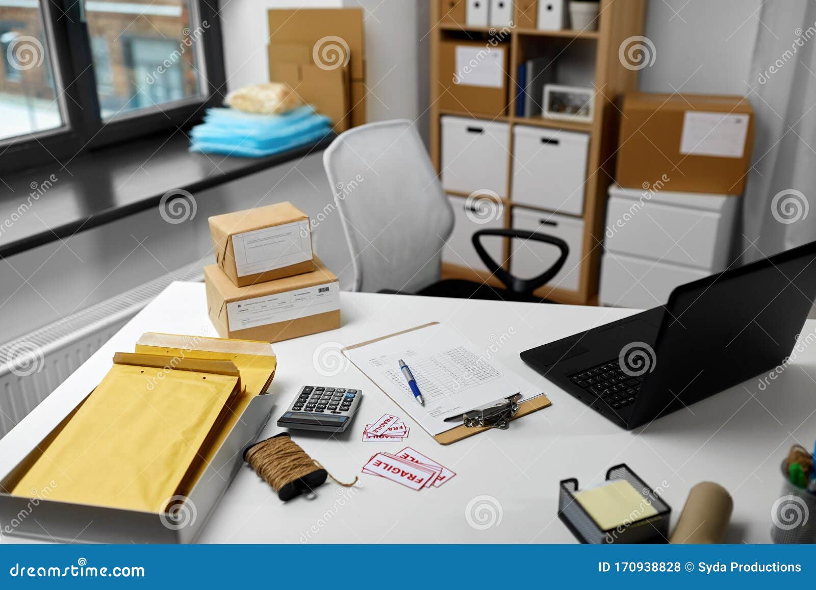 Clipboard, Parcel With Tag And Blurred Stacked Boxes On Background ...
