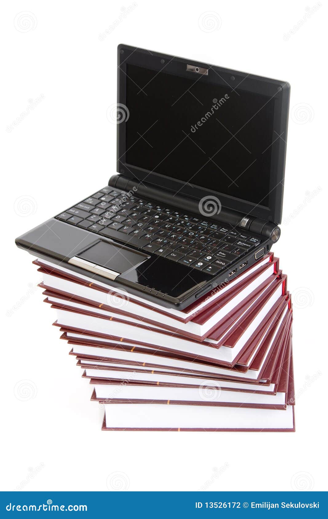 Laptop on a pile of books stock photo. Image of isolated - 13526172