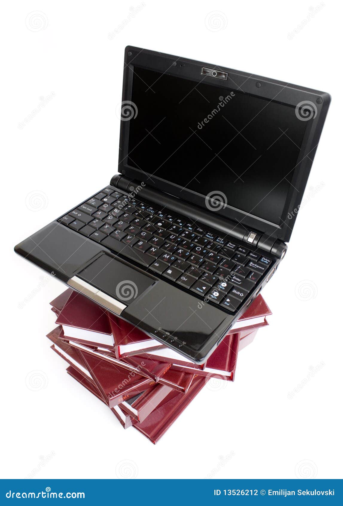 Laptop on a pile of books stock photo. Image of learn - 13526212