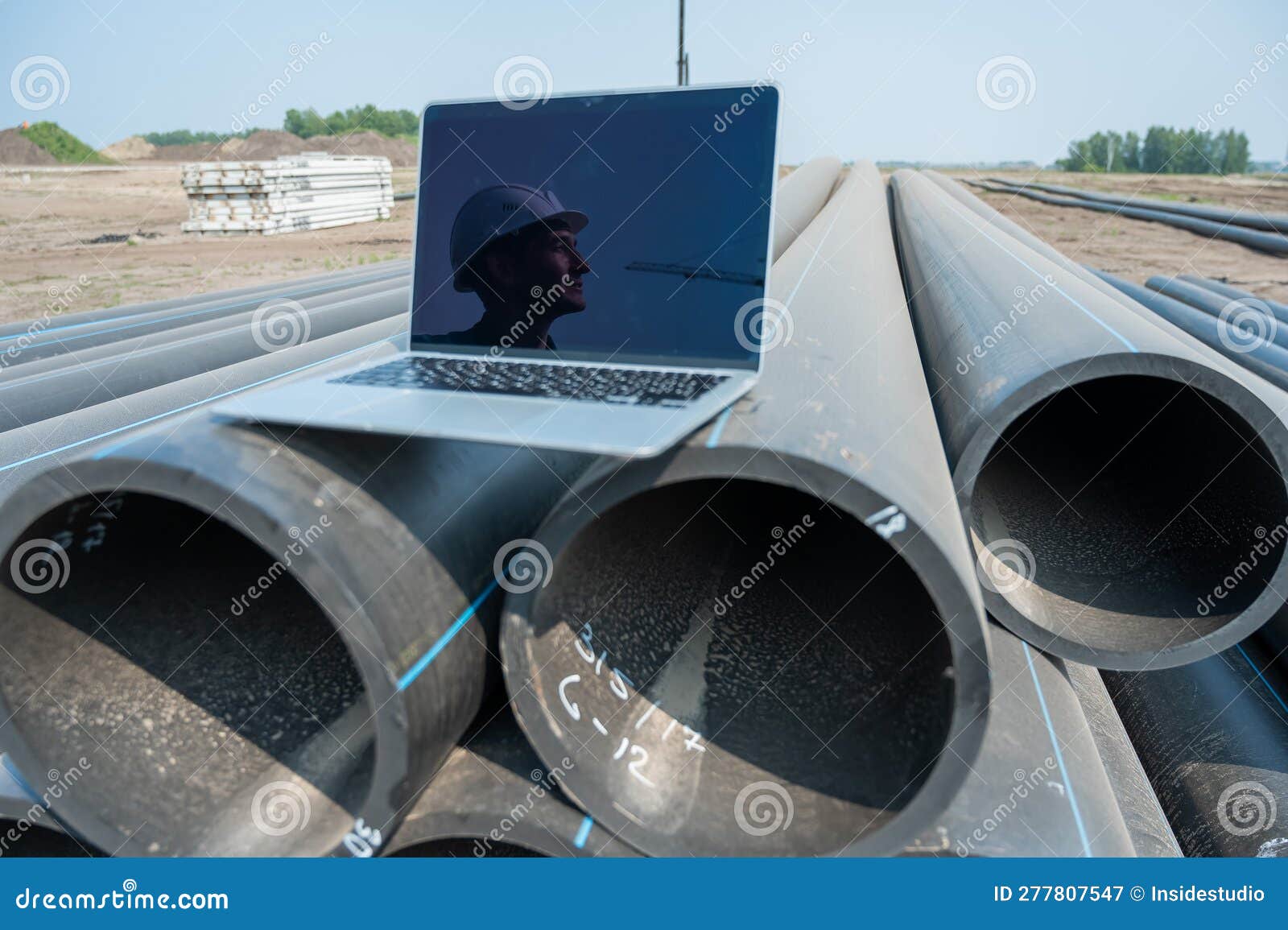 Laptop on Pipes at a Construction Site. Reflection of a Portrait of a ...