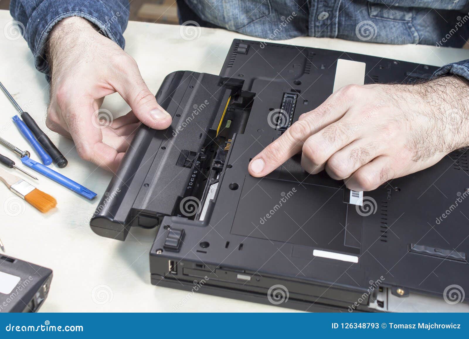 Laptop Service. Removal of the Battery by a Service Technician Stock ...