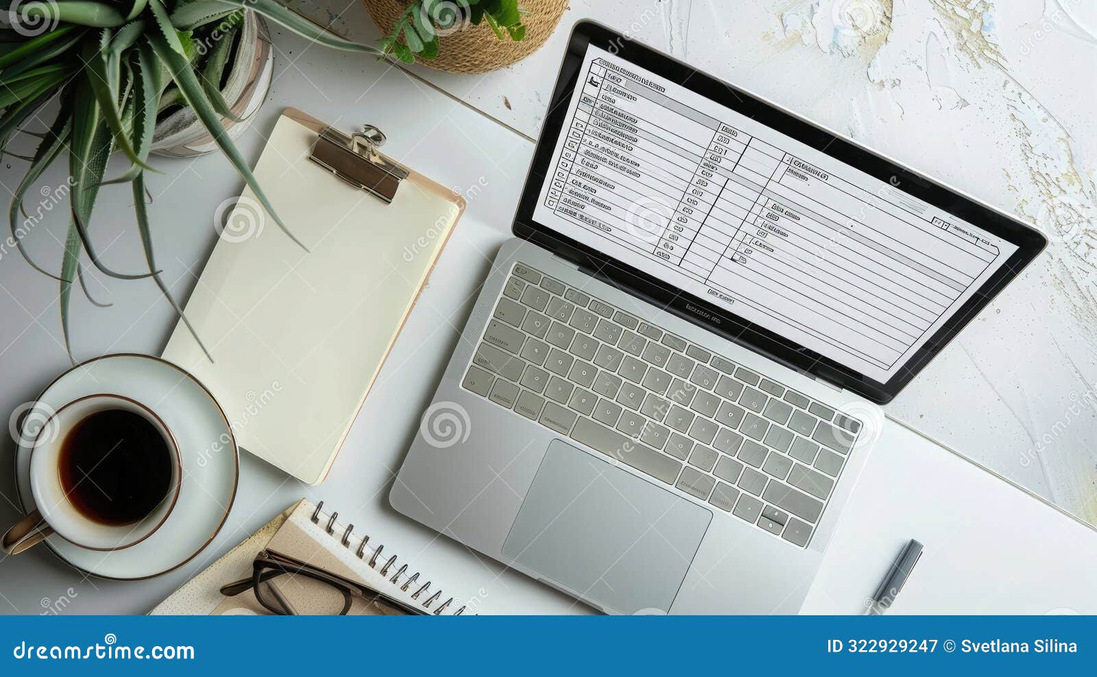 Laptop Showing Questionnaire Form on a Workspace with Notepad and ...
