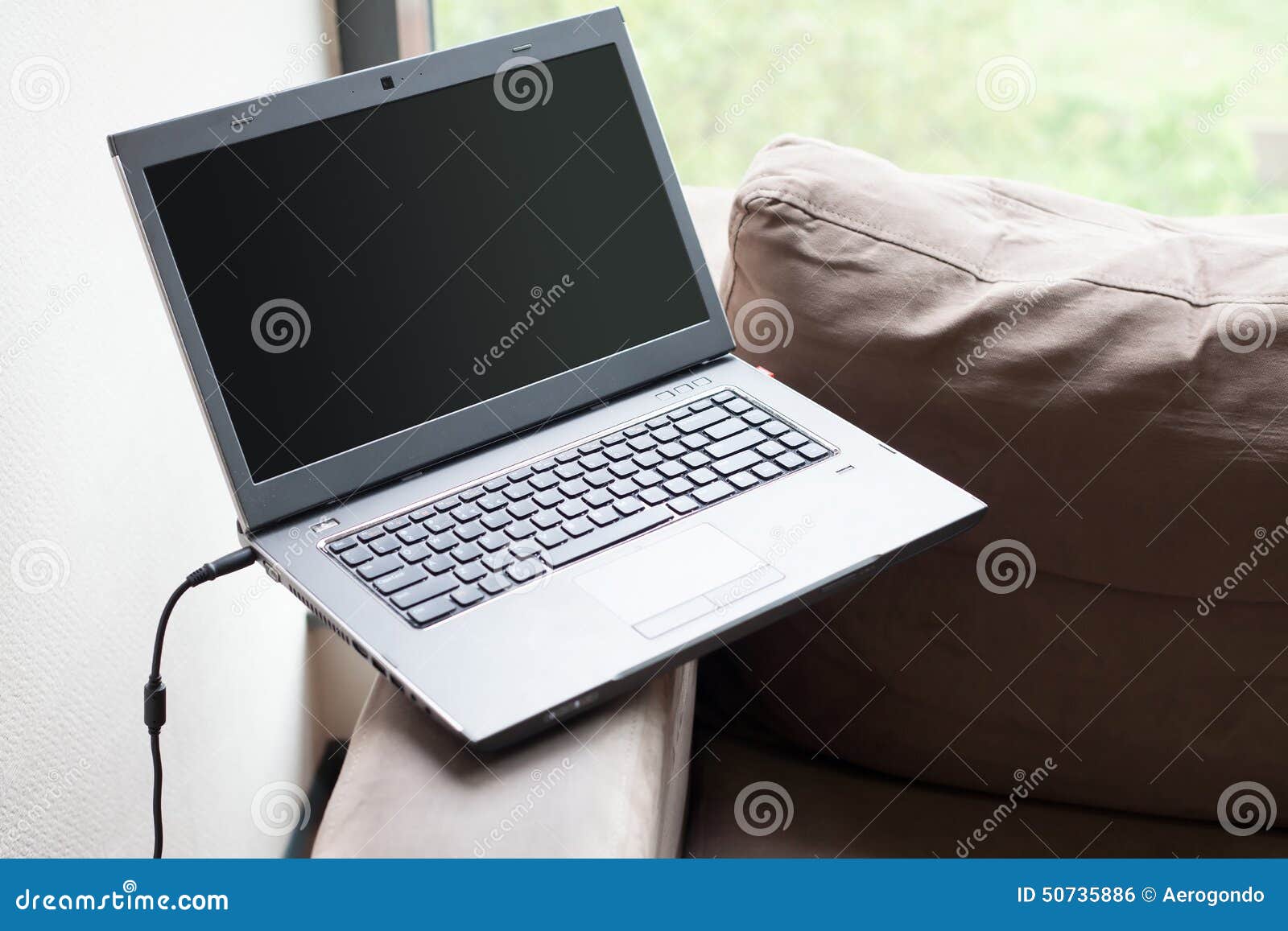 Laptop on sofa handrail stock photo. Image of clean, window - 50735886