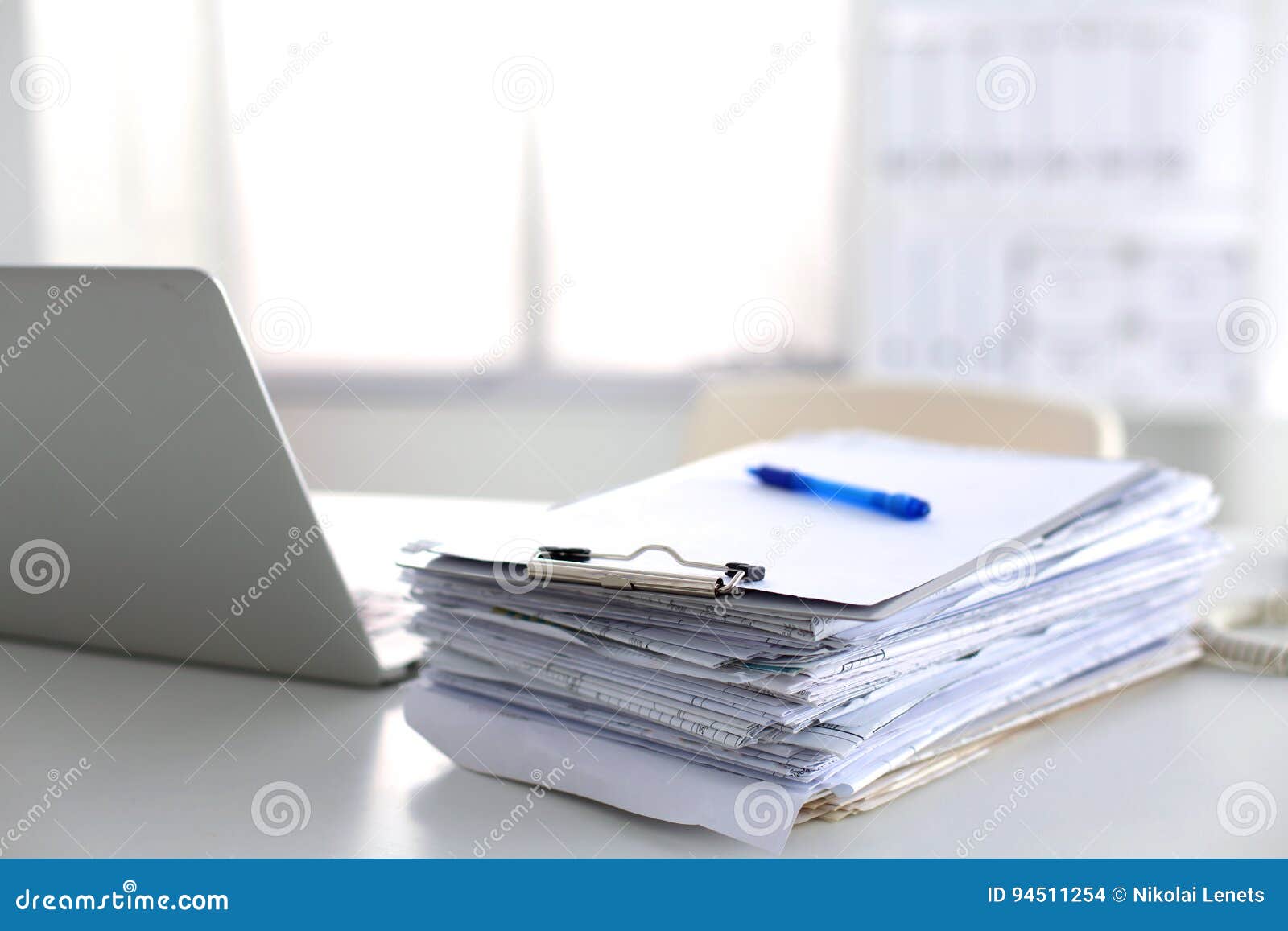 Laptop with Stack of Folders on Table on White Background Stock Photo ...