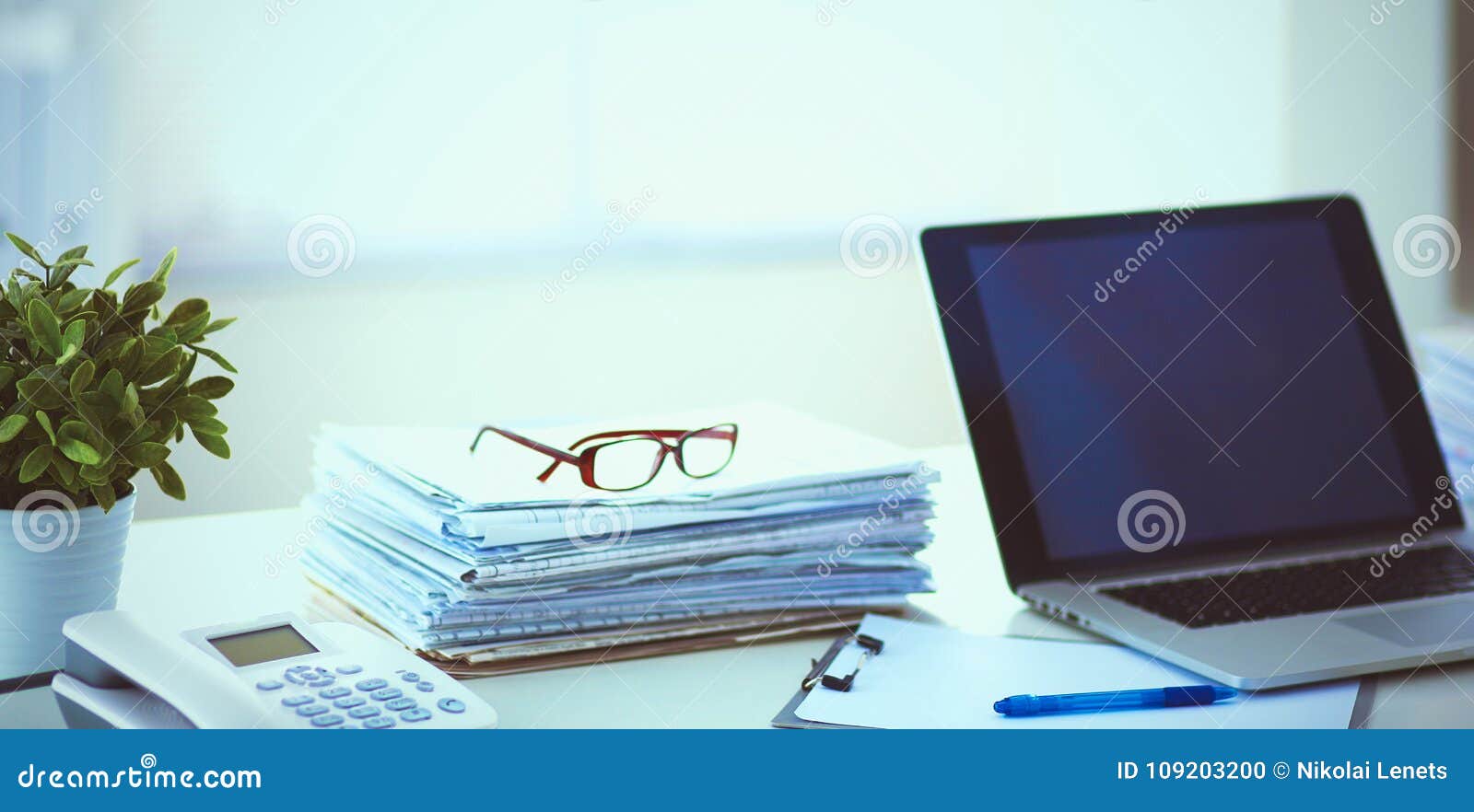 Laptop with Stack of Folders on Table on White Background Stock Photo ...