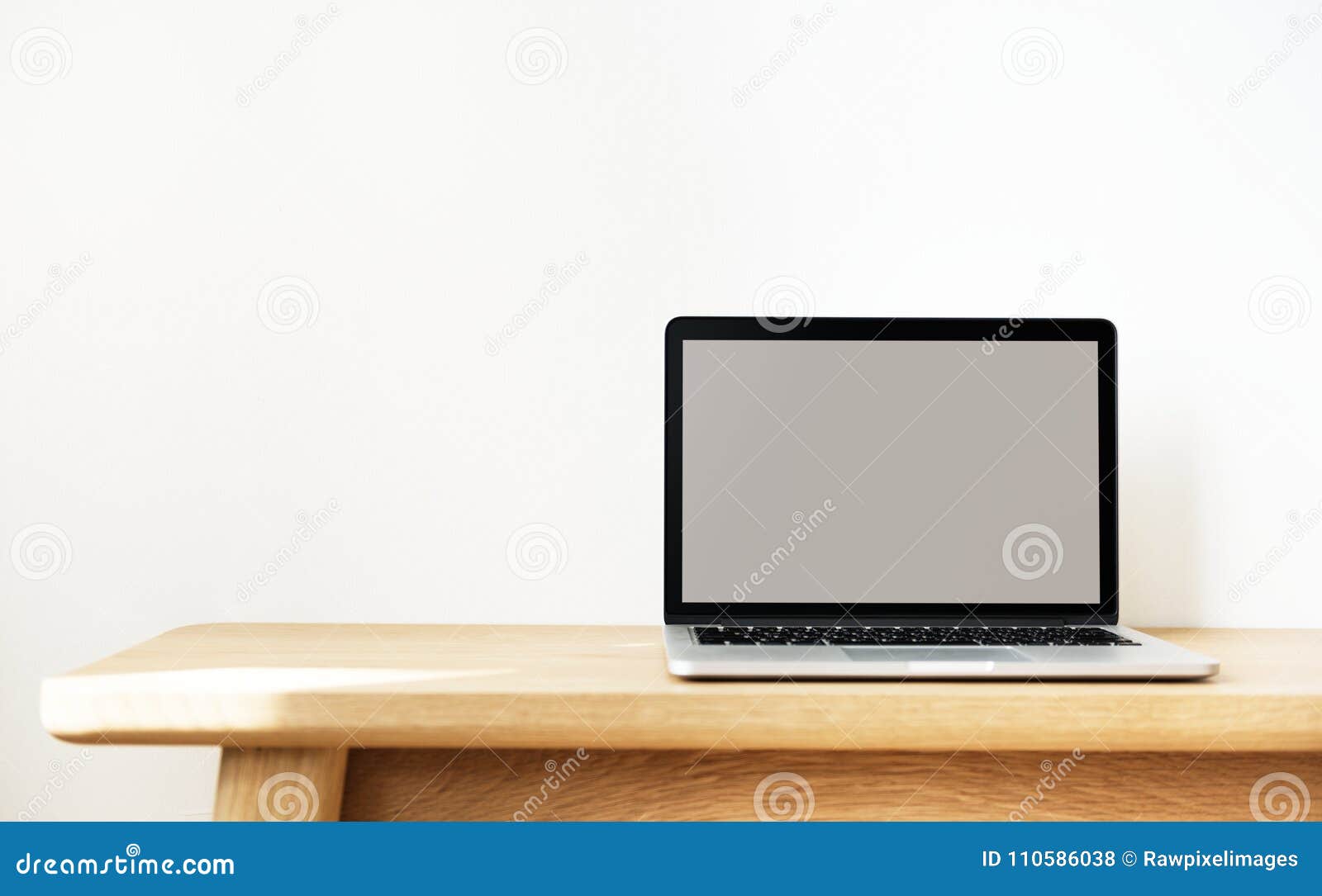 Laptop on a wooden table stock photo. Image of mockup - 110586038