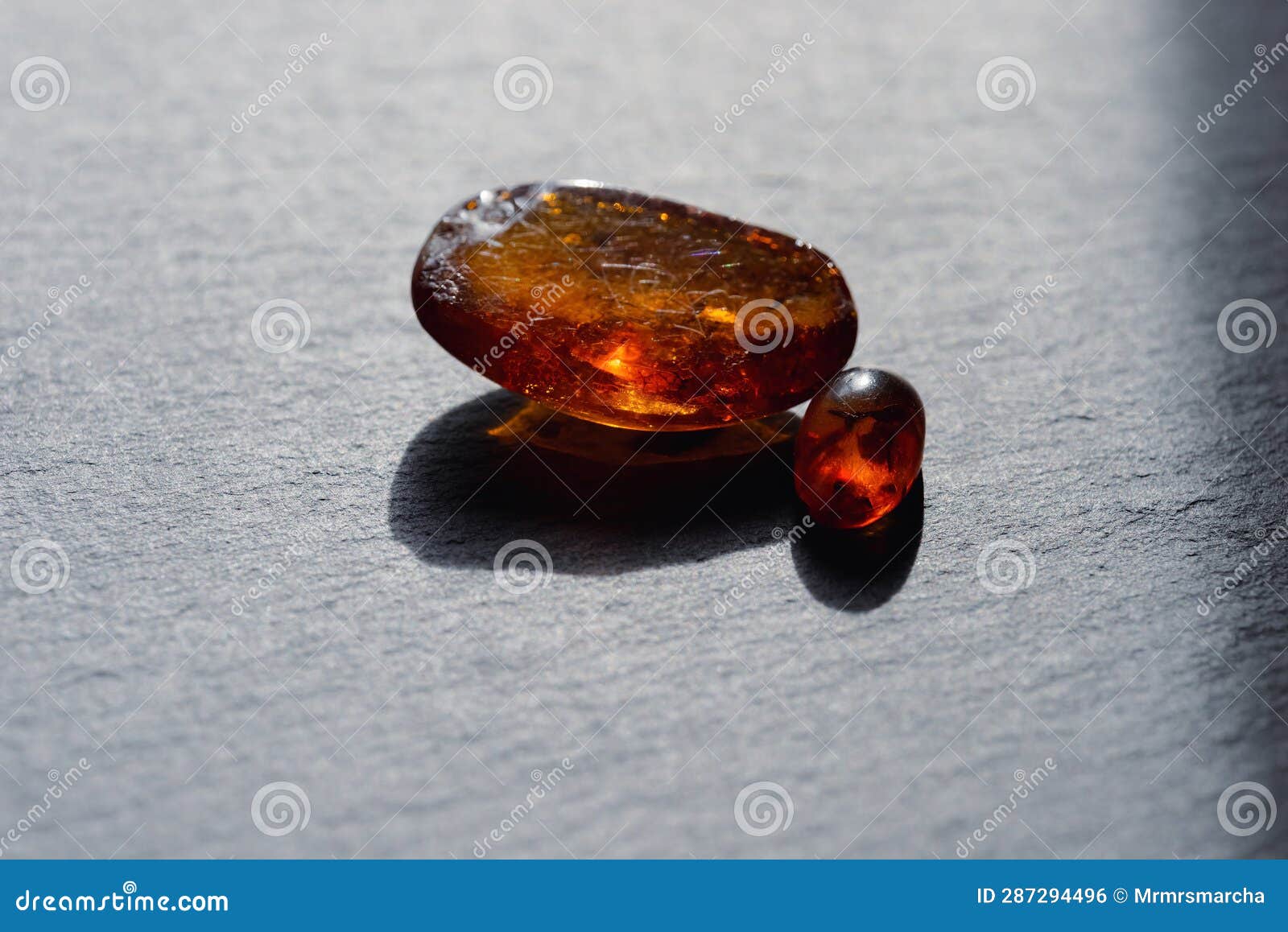 Large Amber Stone Illuminated by Sunlight on a Black Background Close ...