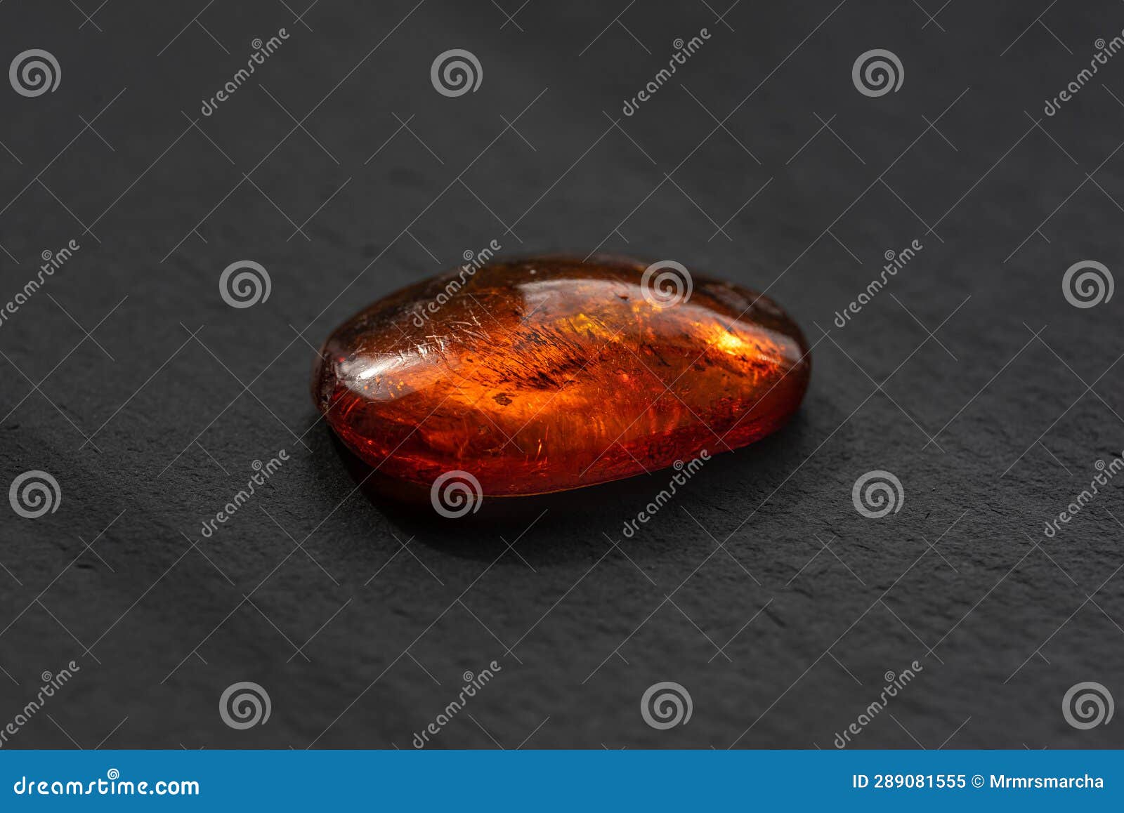 Large Amber Stone Illuminated by Sunlight on a Black Background Close ...