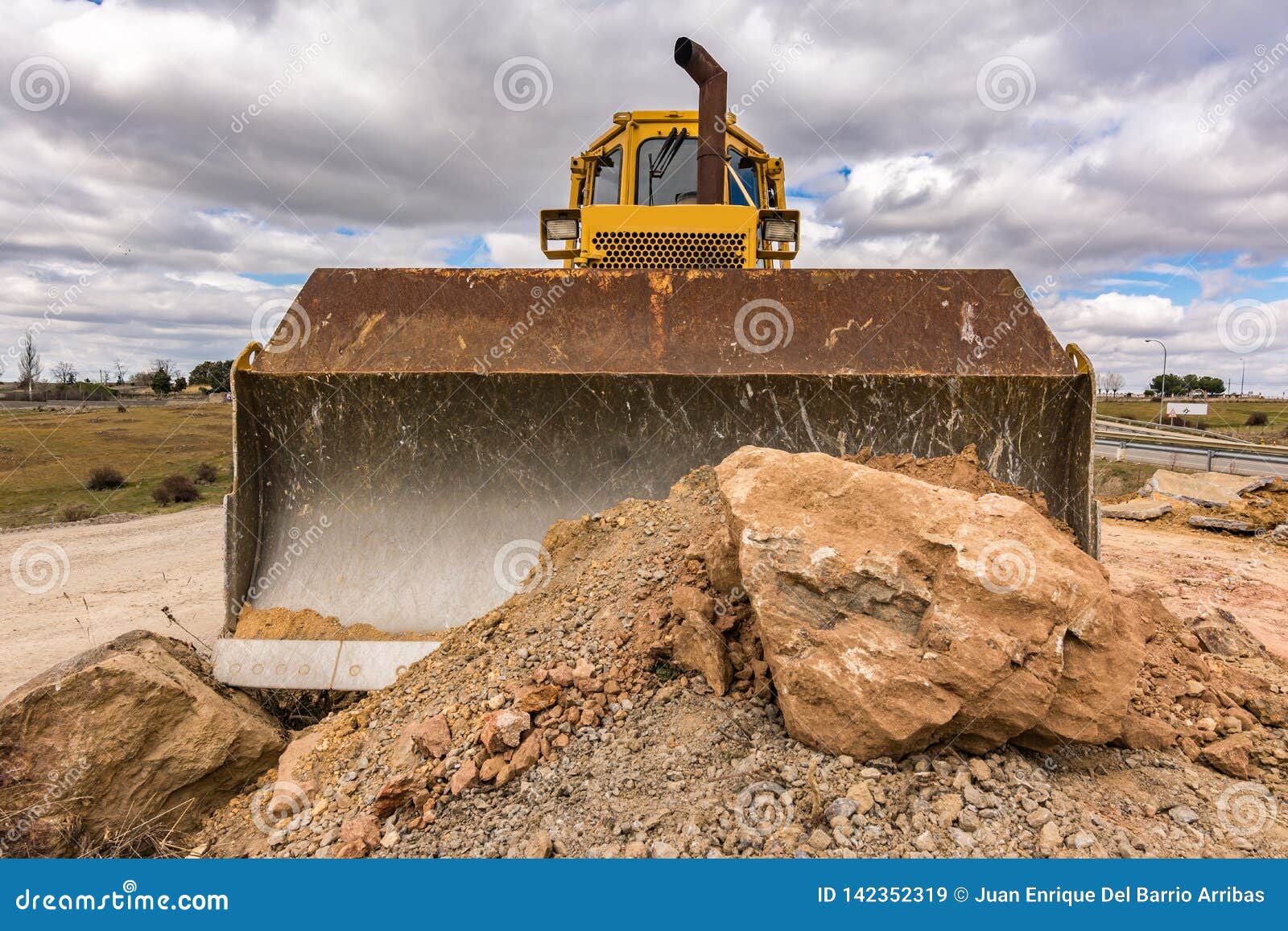 Large Amount of Stone and Earth Moved by a Yellow Excavator Stock Image ...