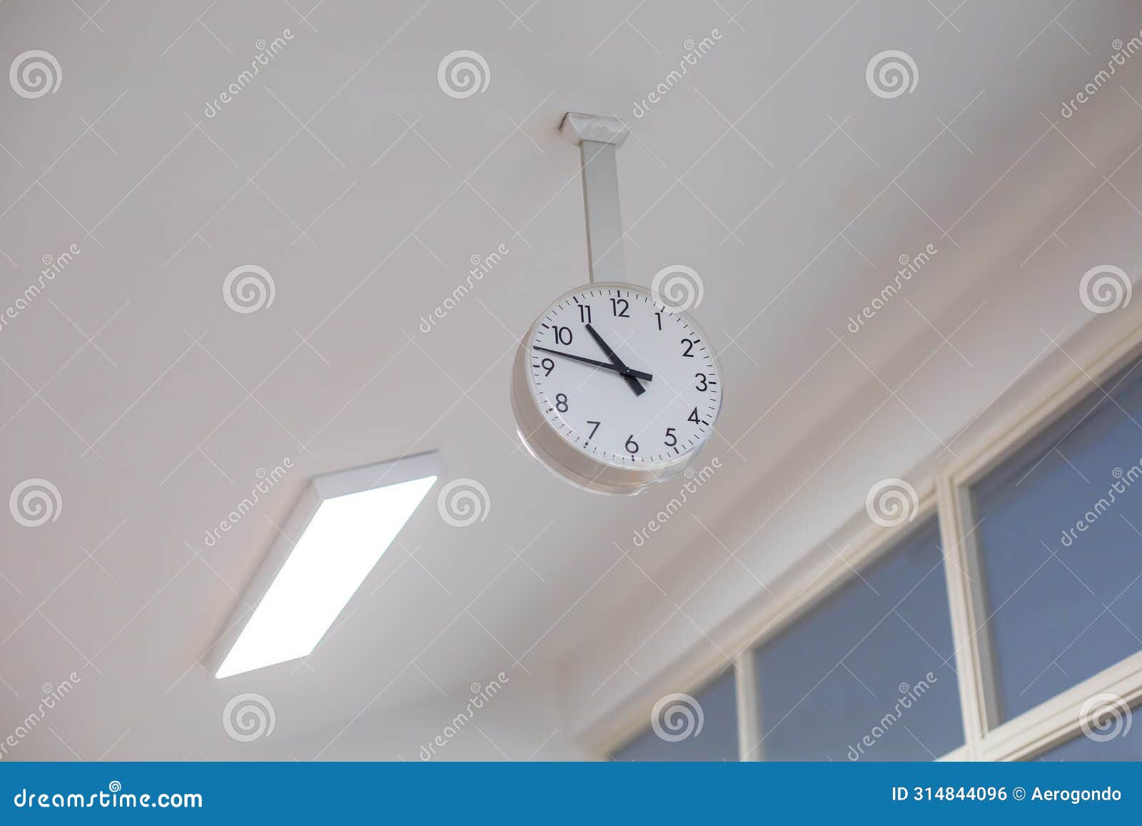 Large Analog Clock Hanging from Ceiling Stock Photo - Image of room ...