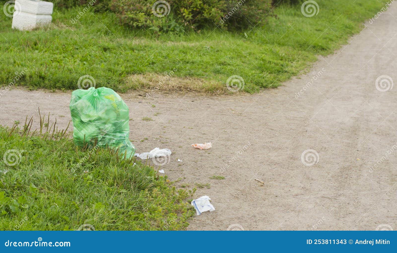 A Large Bag of Garbage and Scattered Garbage in the Park. Stock Image ...