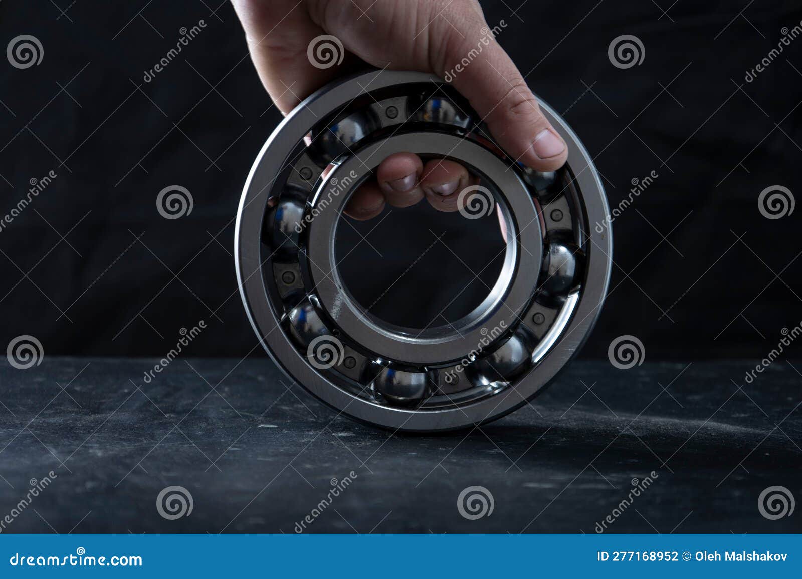 A Large Bearing in a Hand on a Dark Background Stock Photo - Image of ...