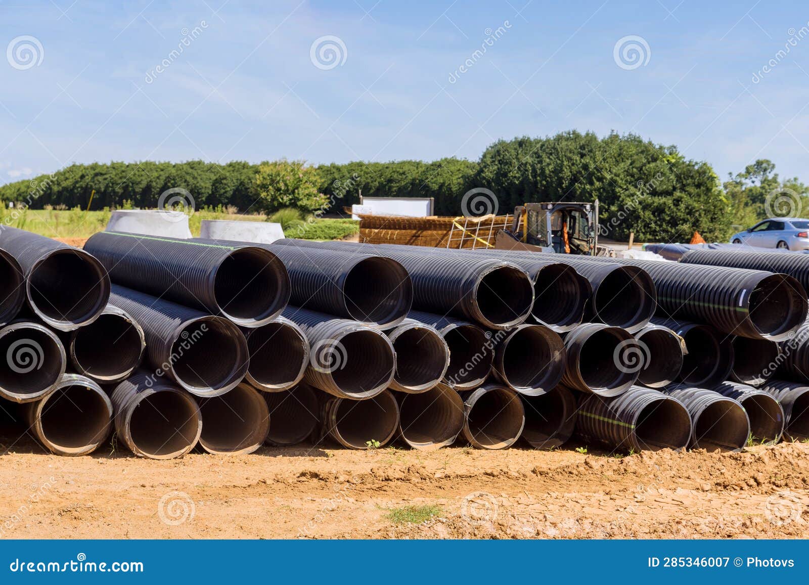Large Black Plastic Pipes for Sewerage are Stacked on Construction Site ...