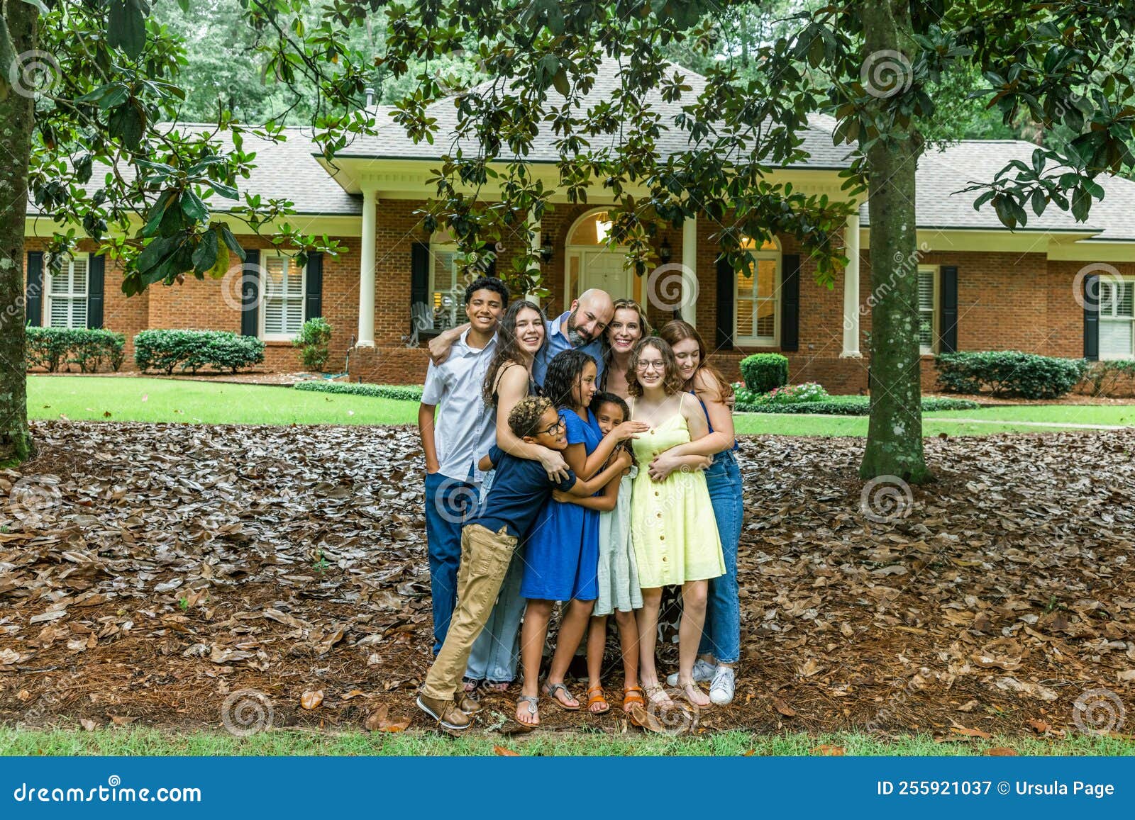 A Large and Blended and Mixed Happy Family Standing in Front of Their ... A Large and Blended and Mixed Happy Family Standing in Front of Their ...