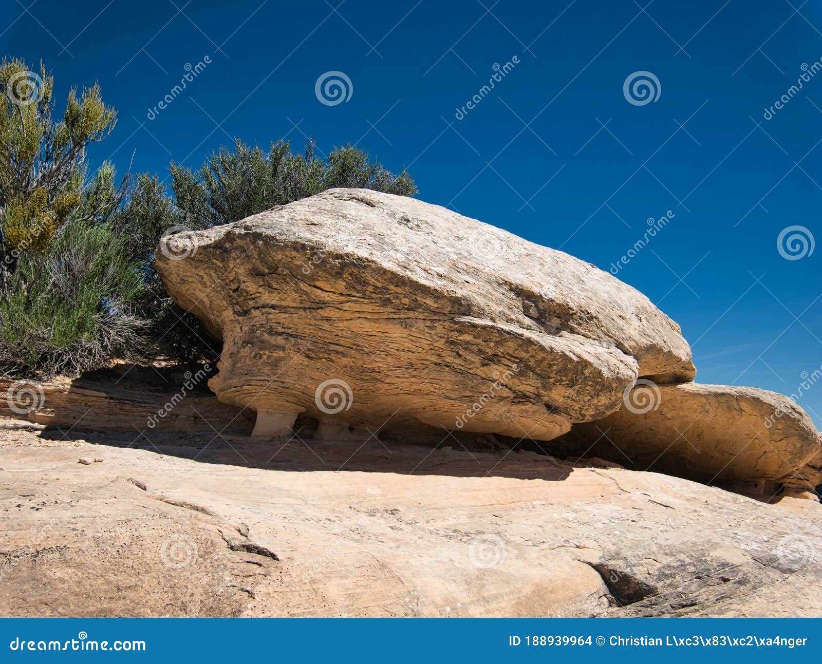 Large Boulder on Natural Stone Columns Stock Photo - Image of shrubs ...