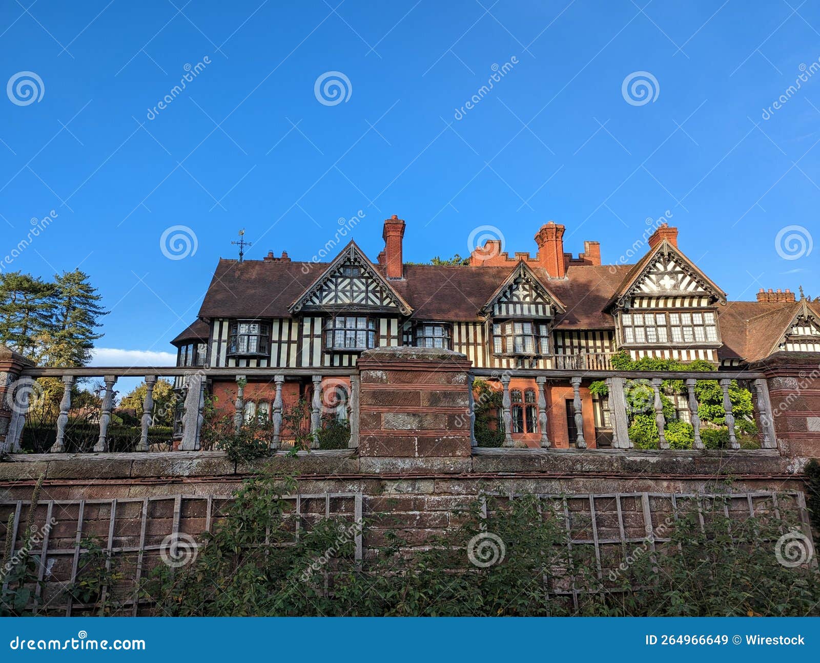 Large Brick Building with Lots of Windows and a Fence Stock Image ...