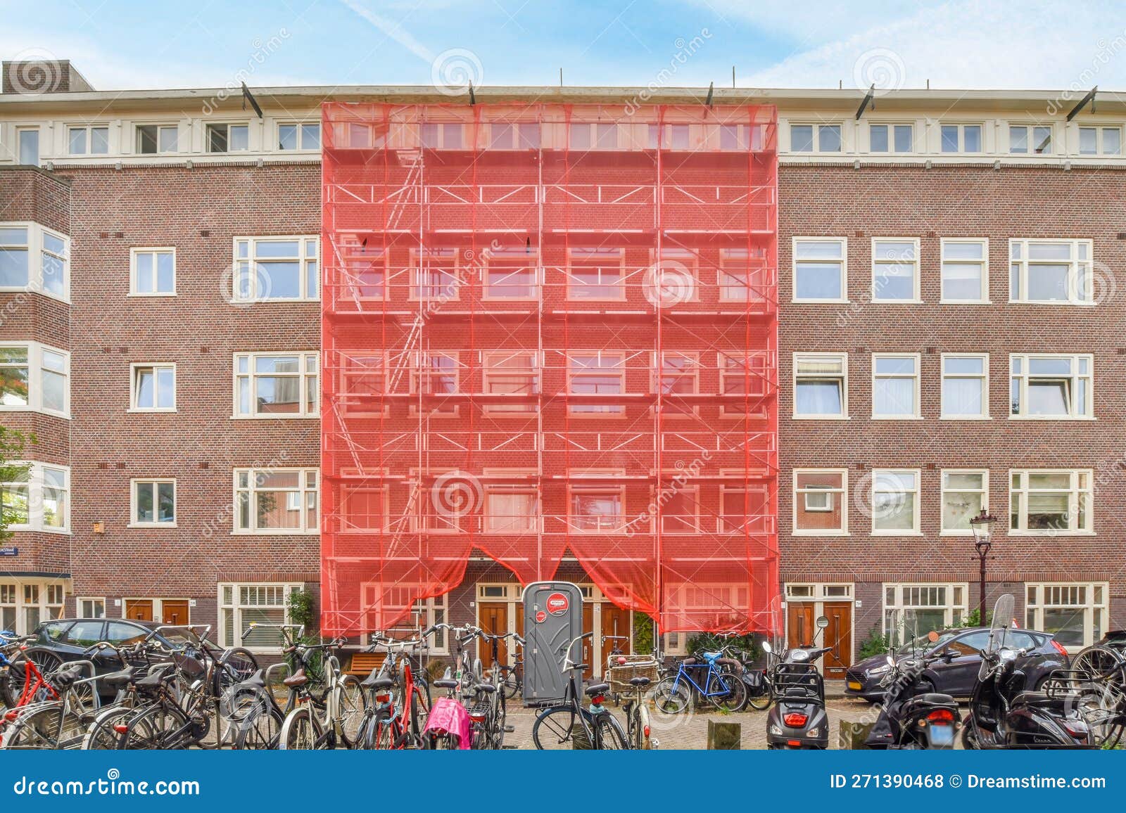 A Large Brick Building with a Red Scaffolding Covered Editorial Stock ...