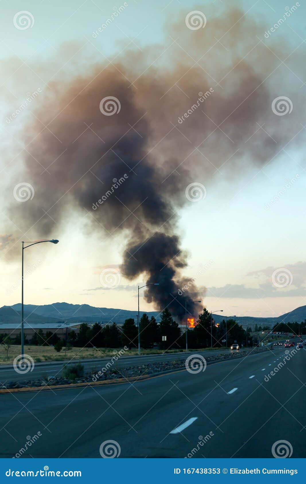 Large Building Fire with Smoke Cloud in the Distance Down the Street ...
